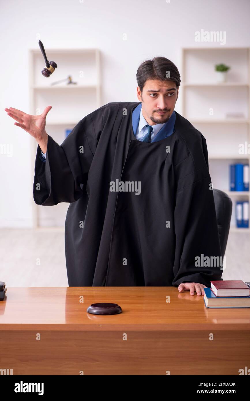 Young judge working in the courtroom Stock Photo - Alamy