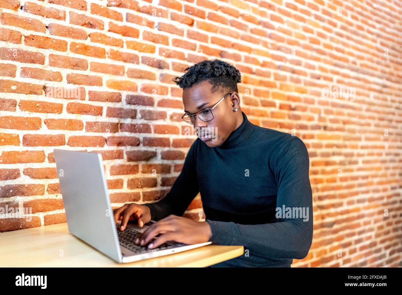 young african man working from his laptop Stock Photo - Alamy