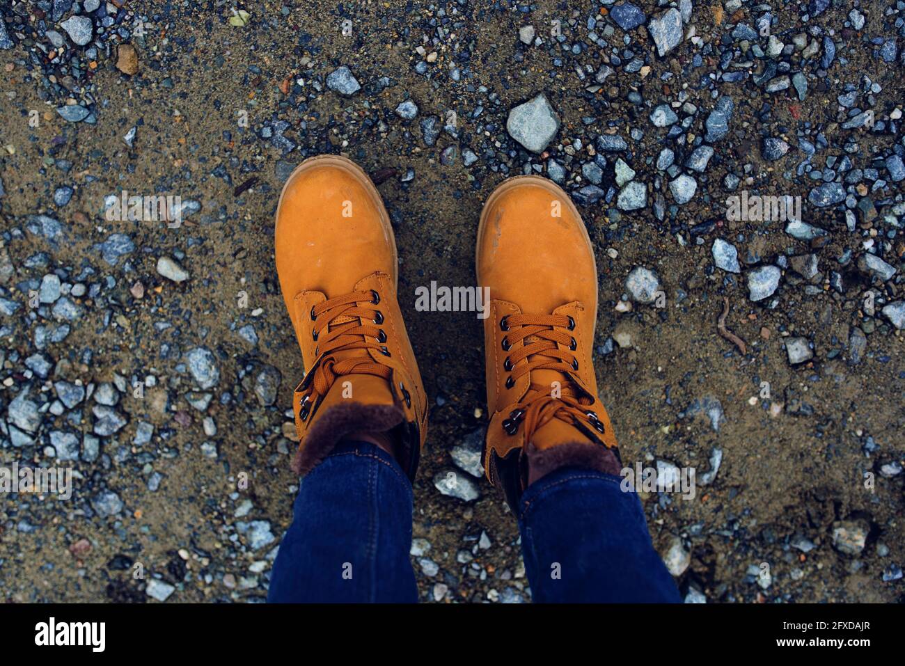 female feet in boots on the ground nature top view Stock Photo - Alamy