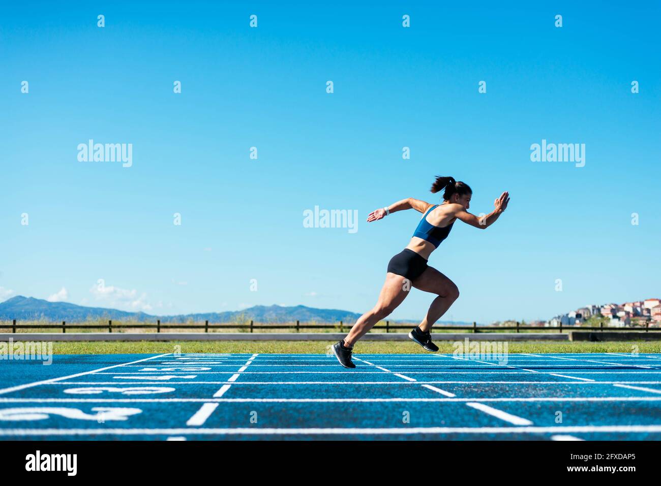 Young woman athlete running on the track Stock Photo - Alamy