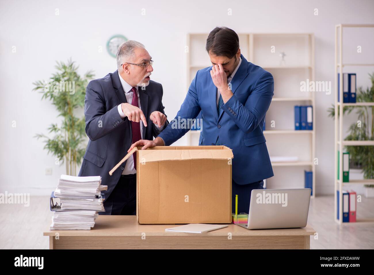 Two employees in dismissal concept Stock Photo - Alamy