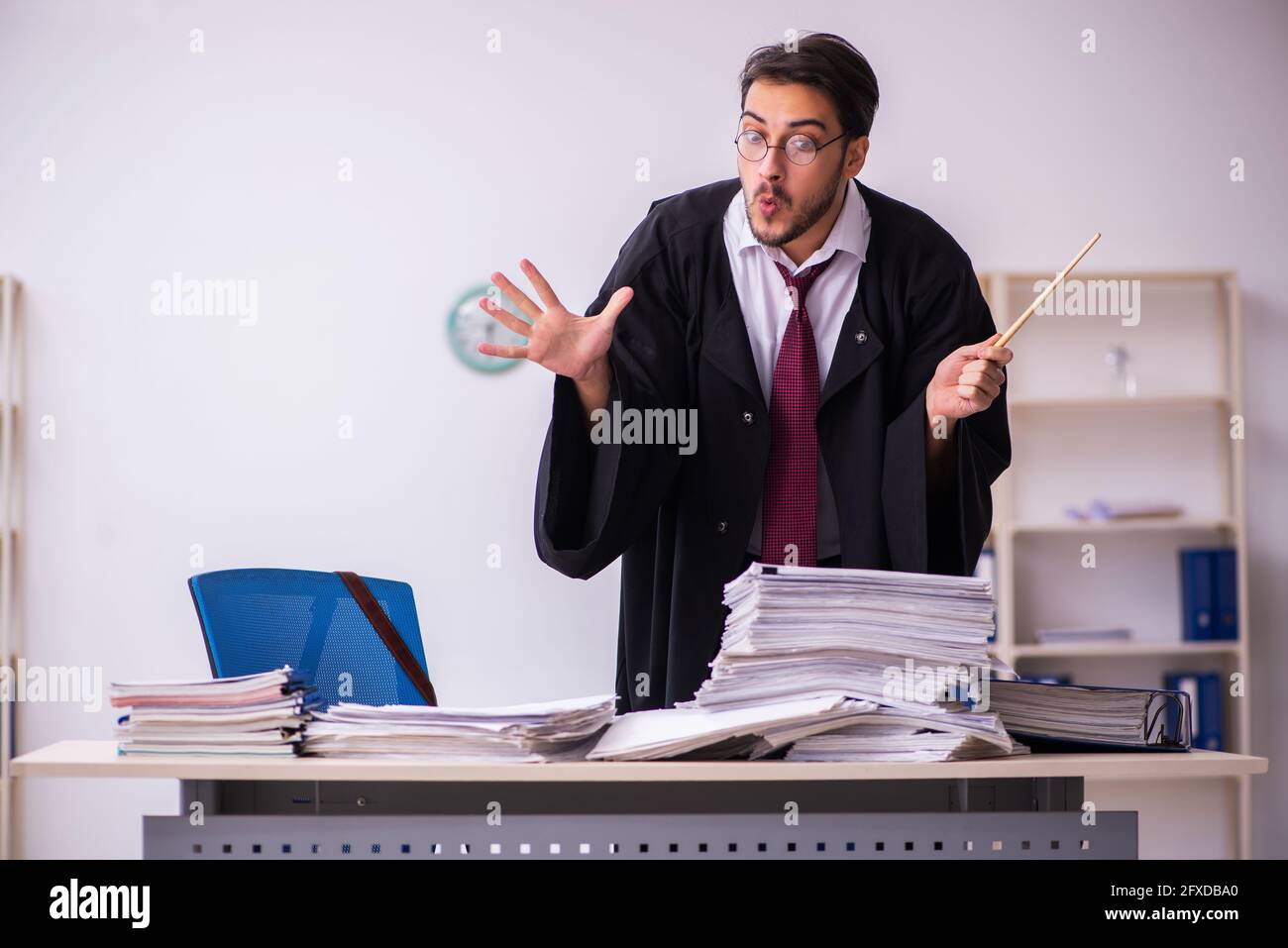 Funny young employee magician and too much work in the office Stock ...