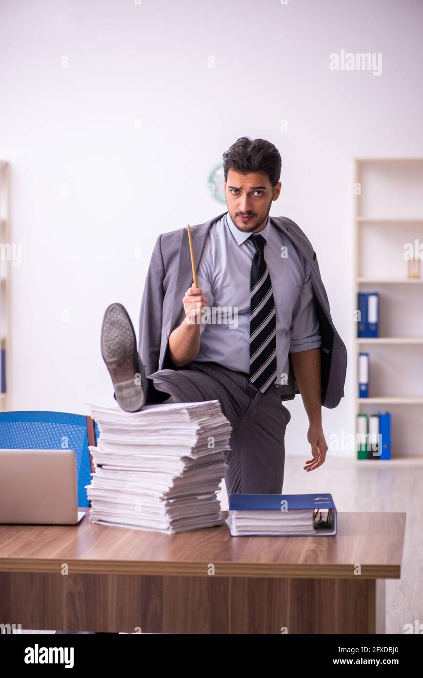 Funny young employee magician and too much work in the office Stock ...