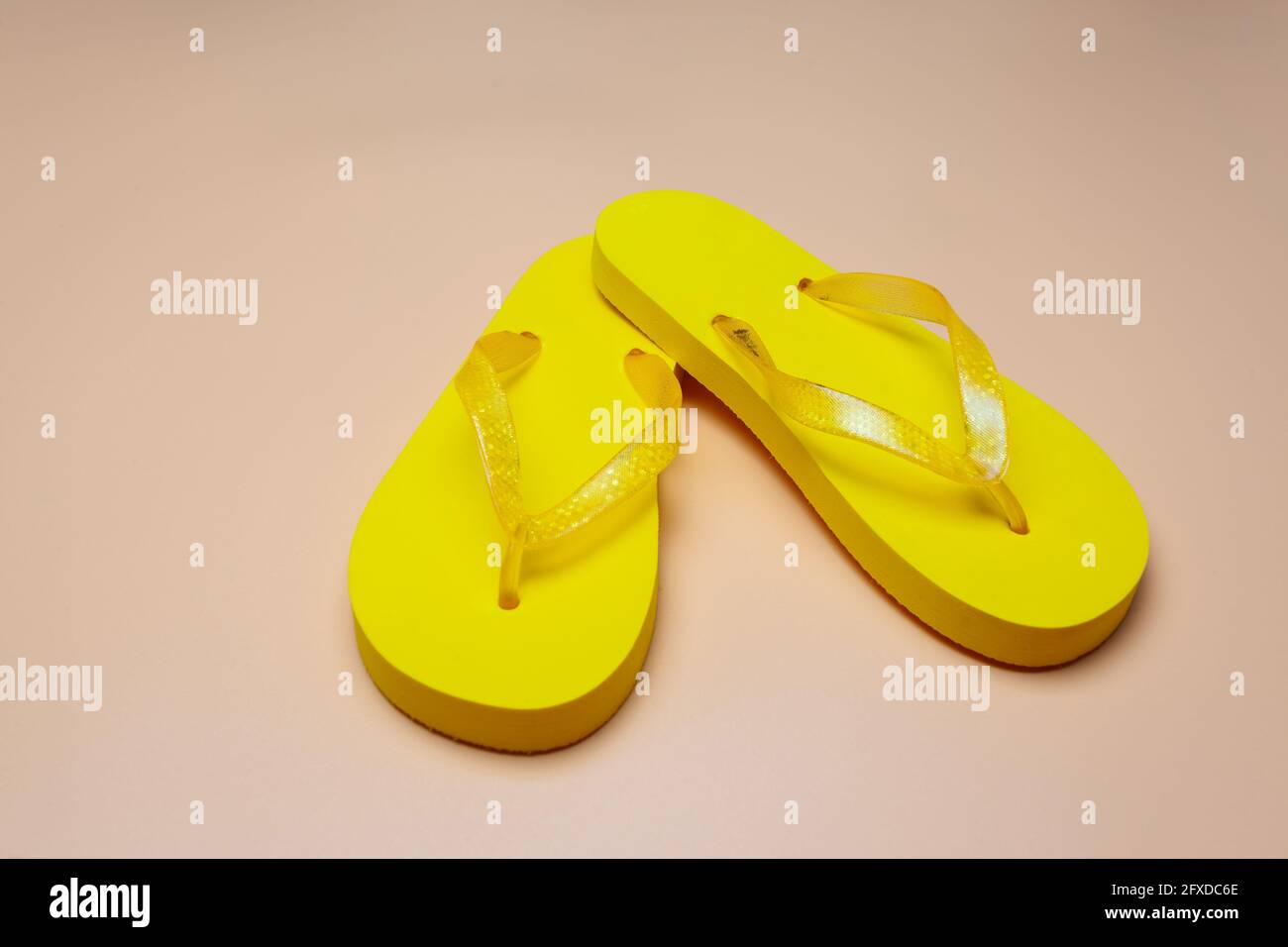 yellow slippers on a sand-colored background. Copy space Stock Photo ...