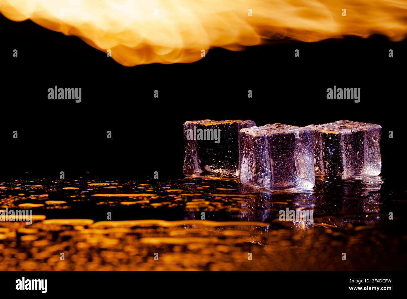 fire and ice cubes on a black background, place under the text Stock ...