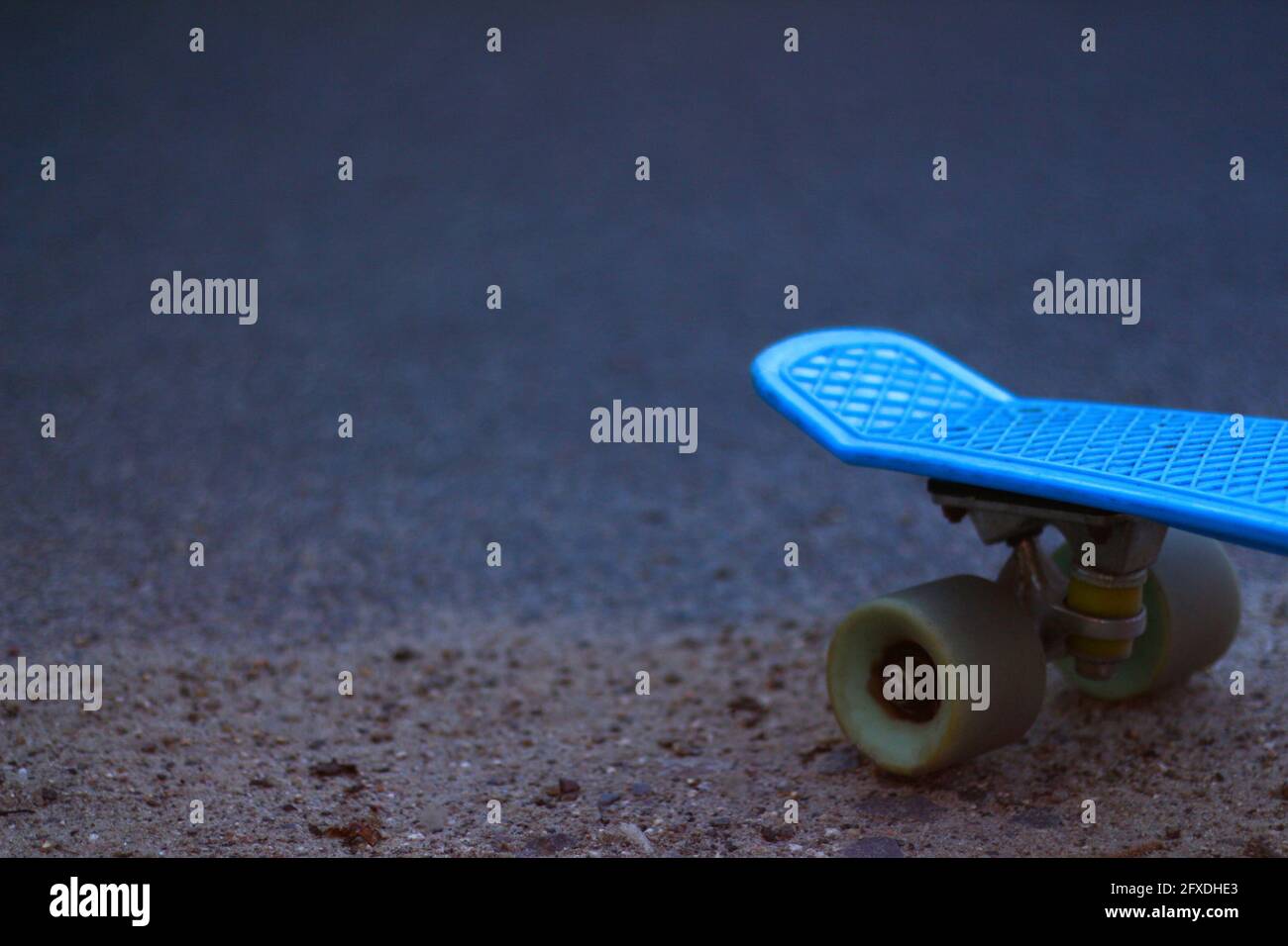 Defocus close up blue skateboard at park. Head of skateboard and wheel ...