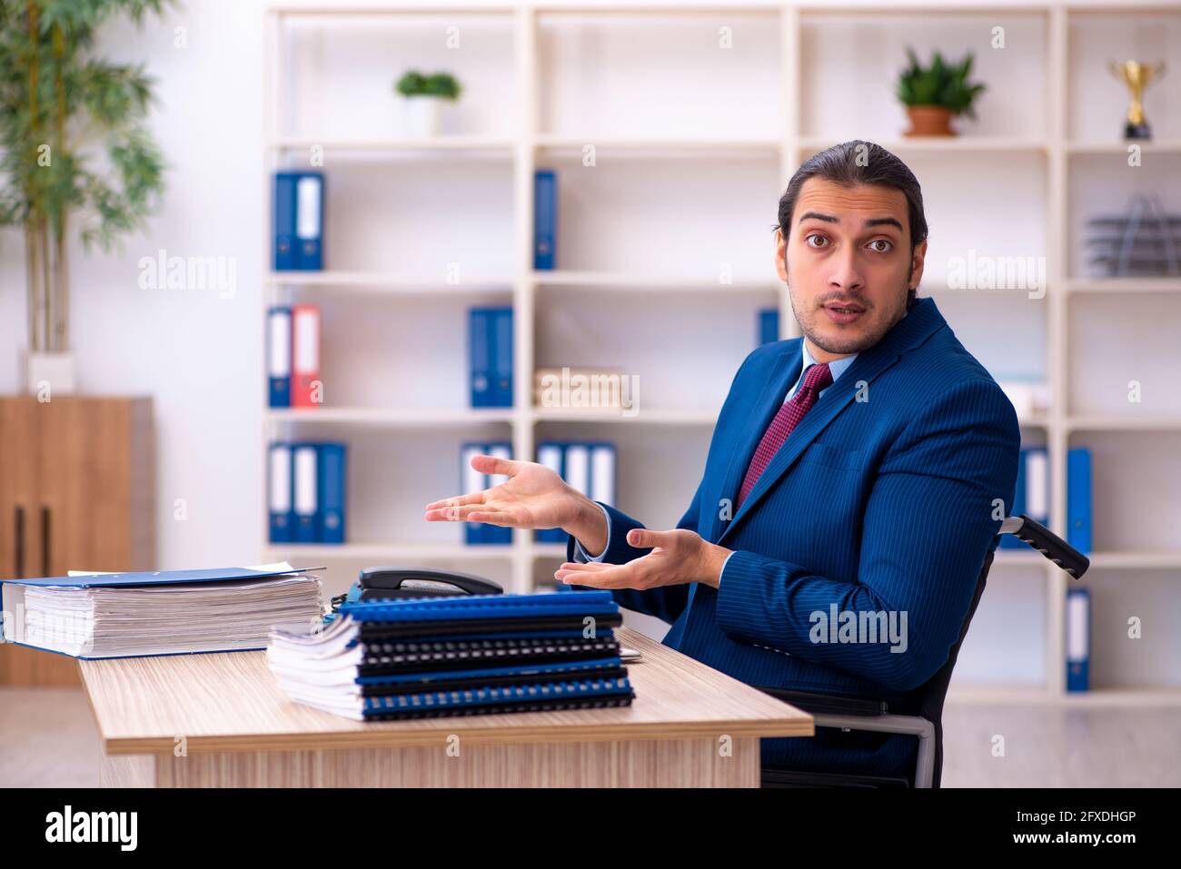 Young male disabled employee working in the office Stock Photo - Alamy