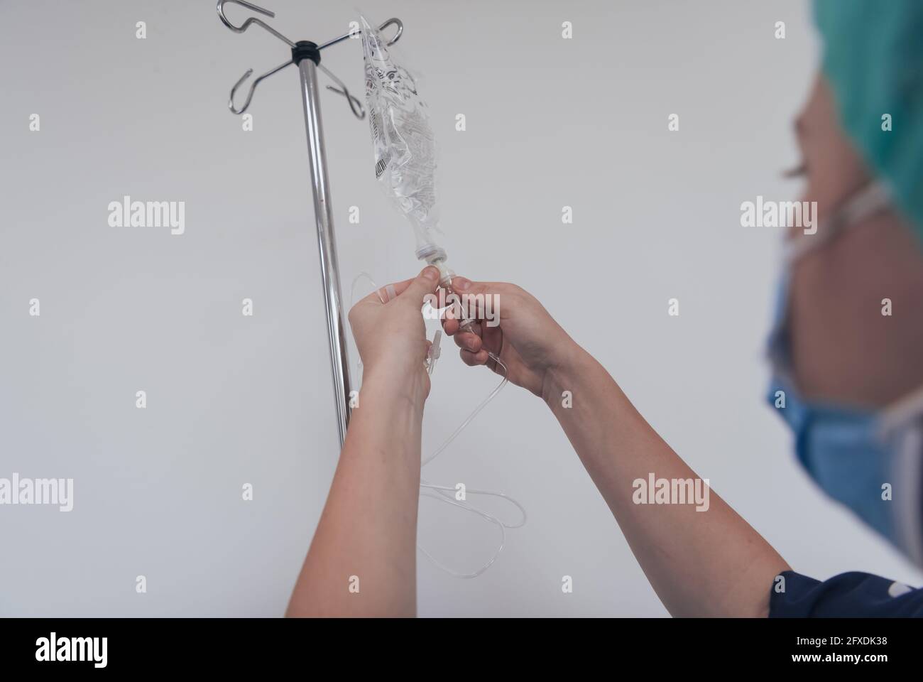 General practitioner holding intravenous drip infusion. Doctor handling ...