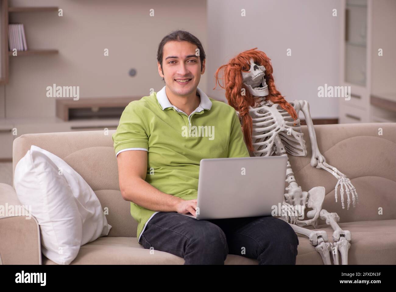 Human skeleton sitting with laptop computer hi-res stock photography ...