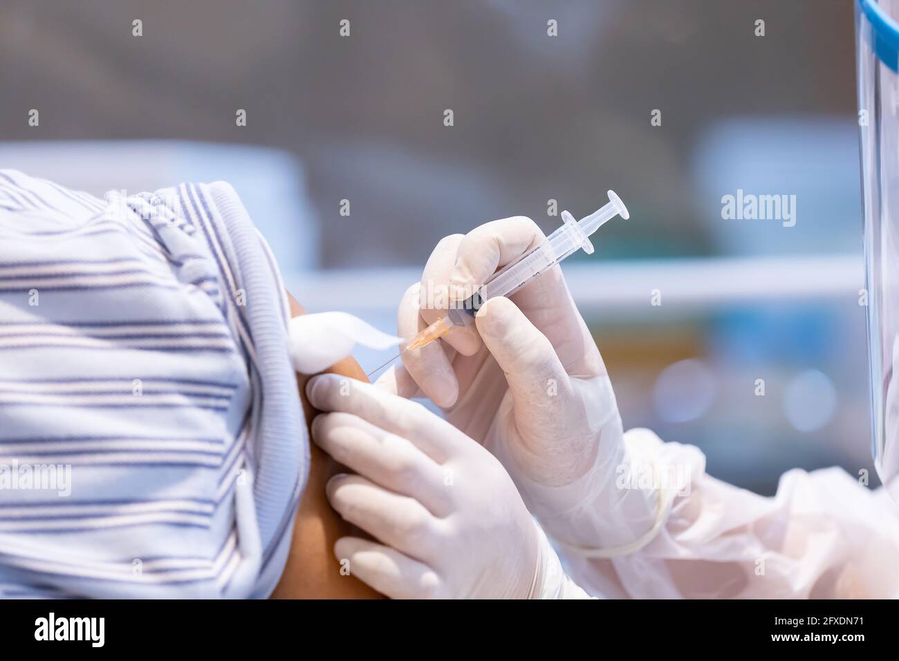 Closeup covid-19 vaccine injecting into patient arm shoulder with ...