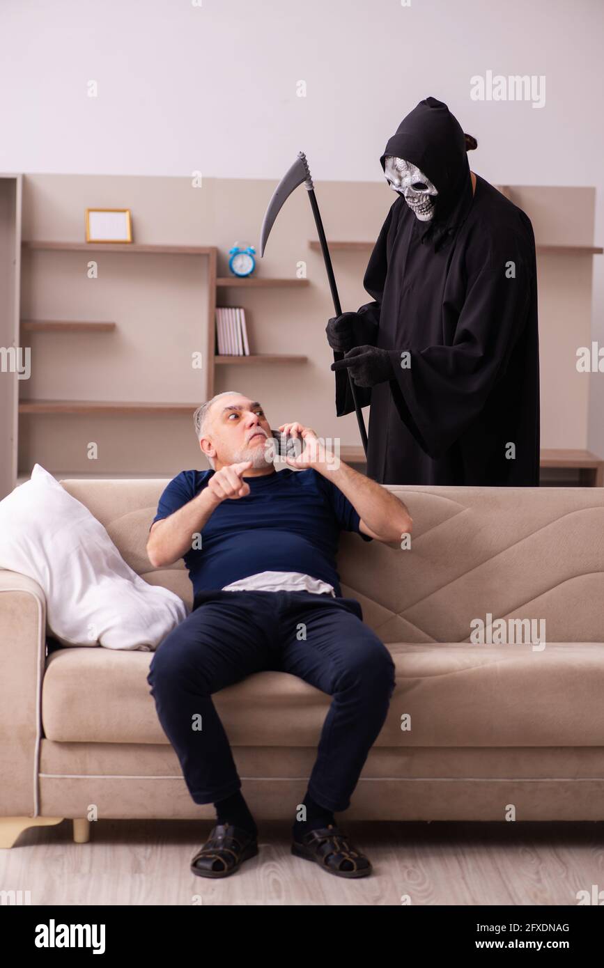 Devil coming to old dying man Stock Photo - Alamy
