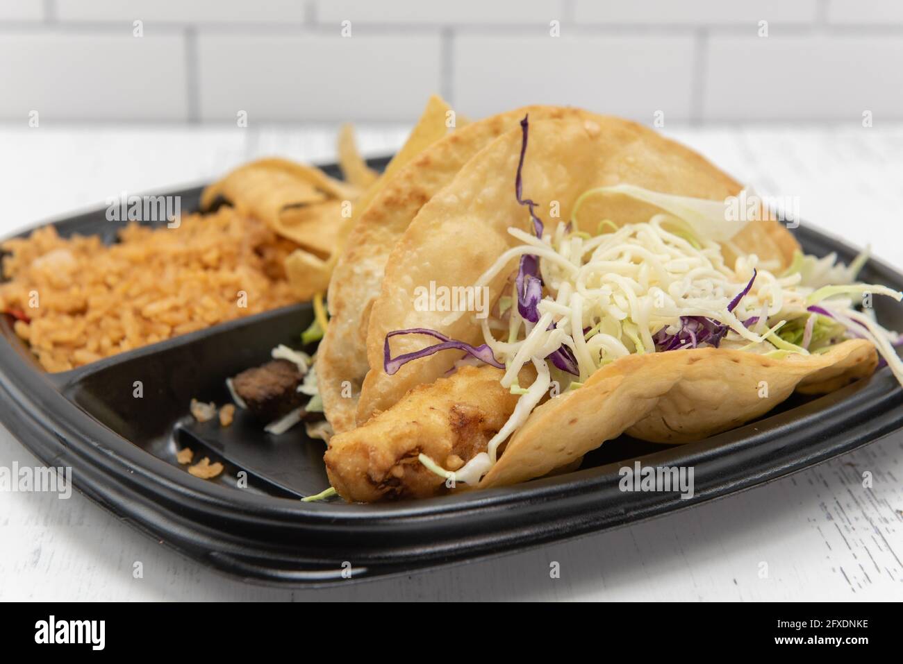 Two kinds of tacos served with all the fillings, rice, and refried ...