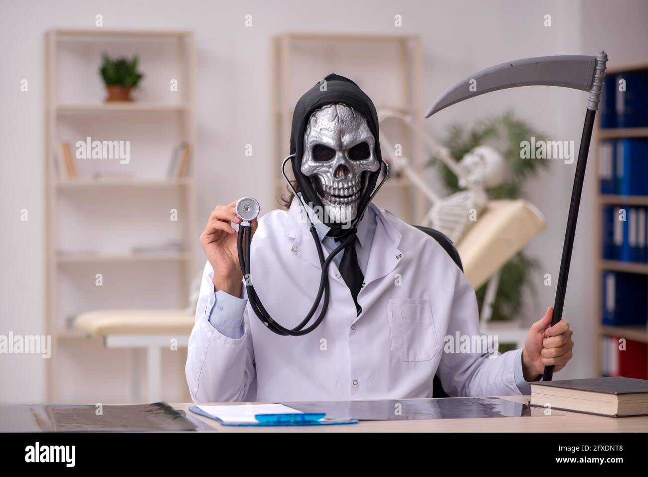Reaper grim doctor examining skeleton patient in the clinic Stock Photo ...