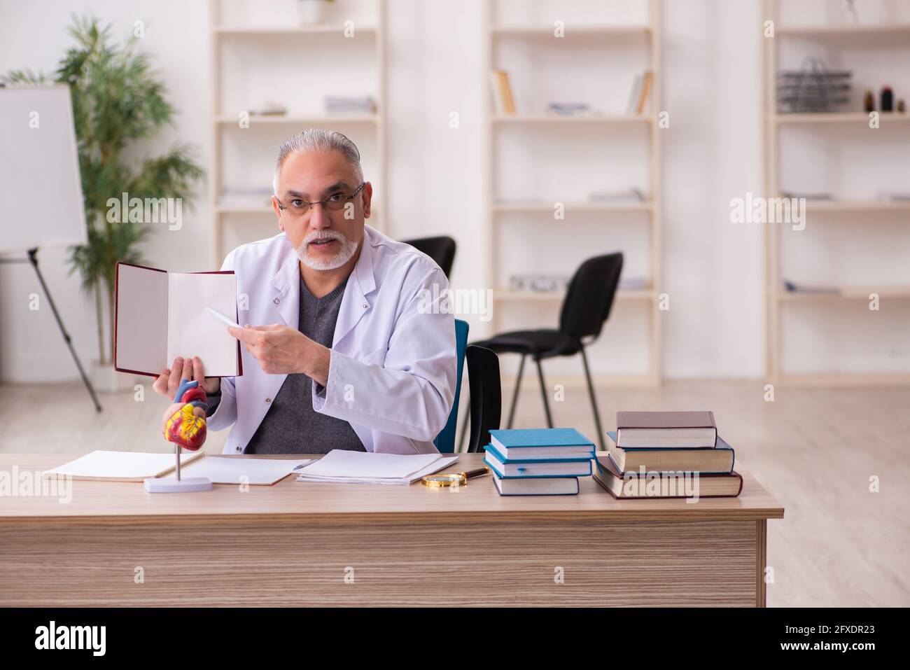 Old doctor cardiologist sitting in the classroom Stock Photo - Alamy