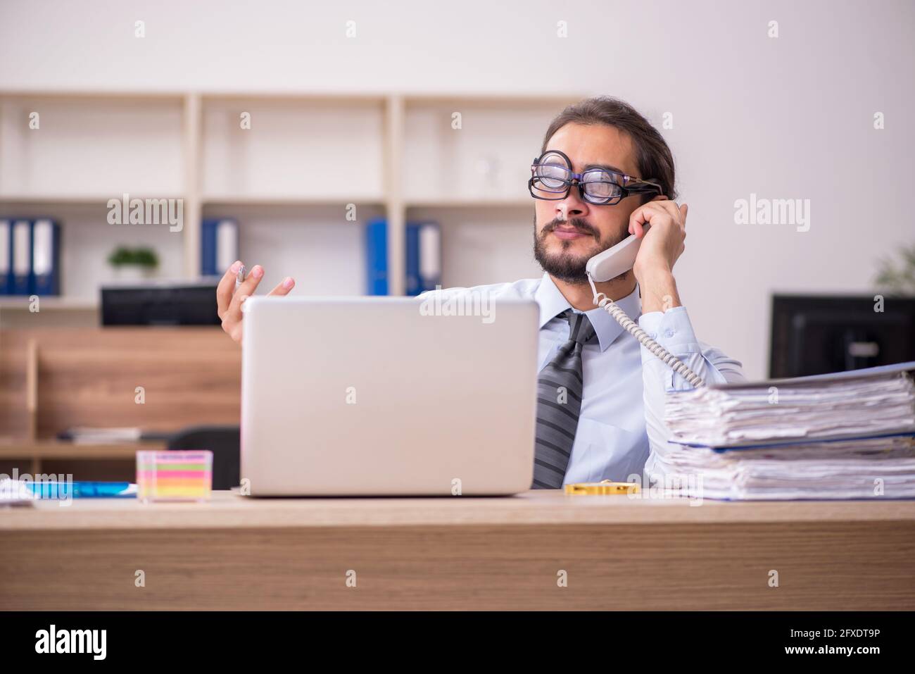Young funny employee working at workplace Stock Photo - Alamy