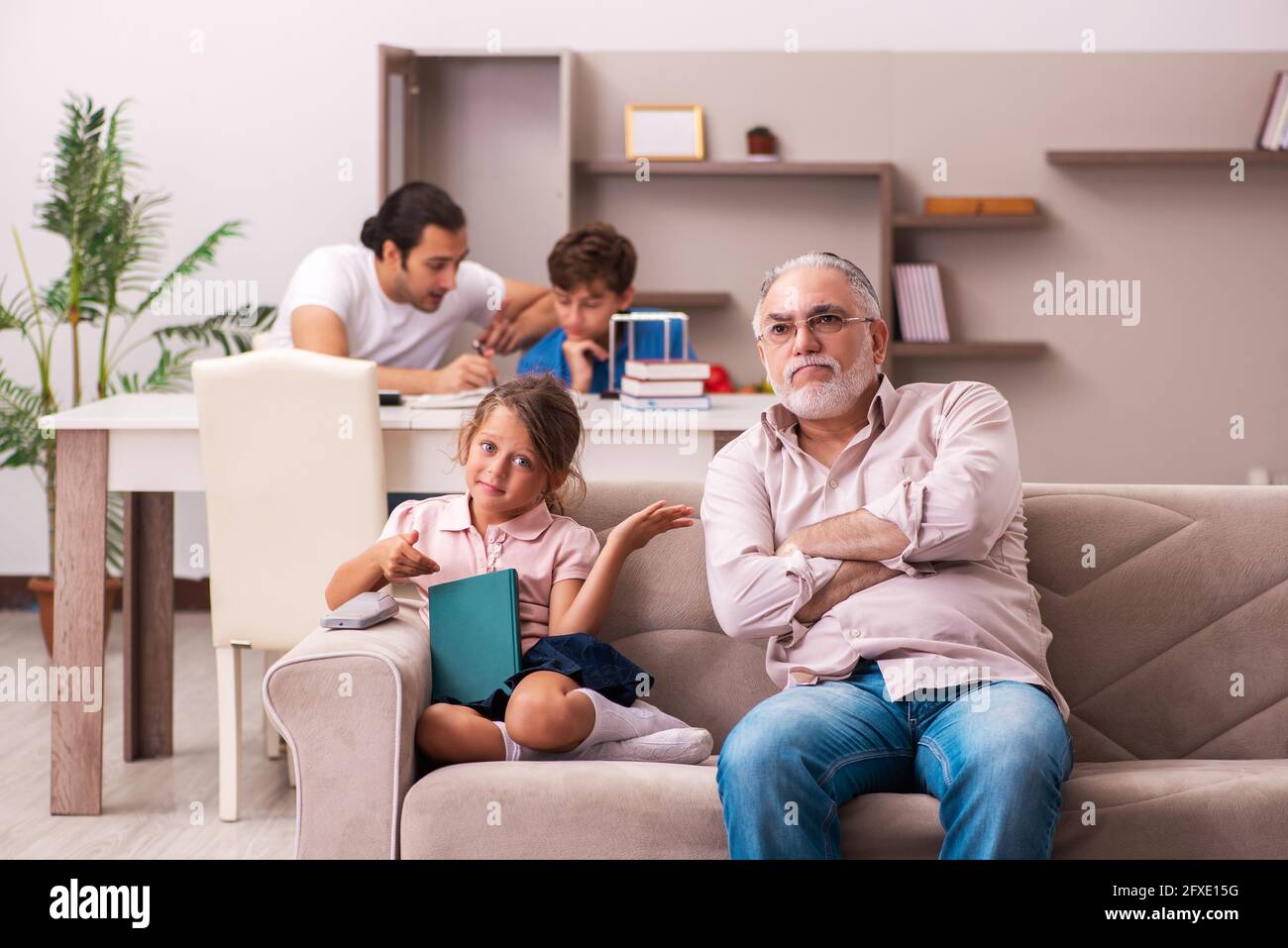 Three generations at home in early development concept Stock Photo - Alamy