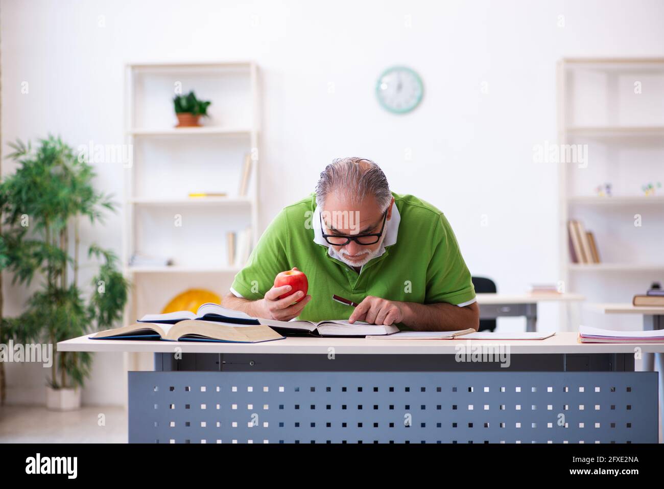 Male teacher eating apple hi-res stock photography and images - Alamy