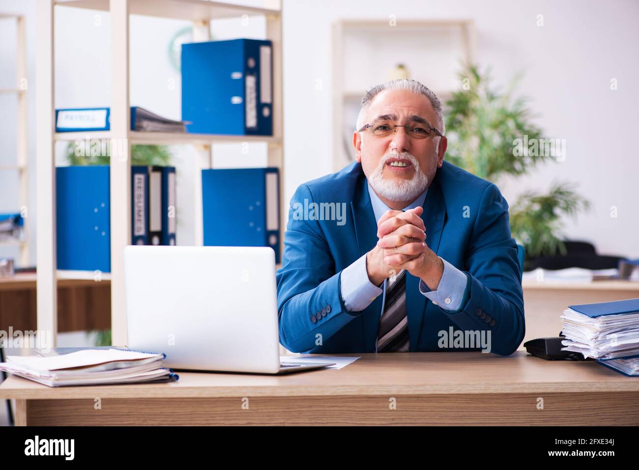 Senior male bookkeeper unhappy with excessive work at workplace Stock ...