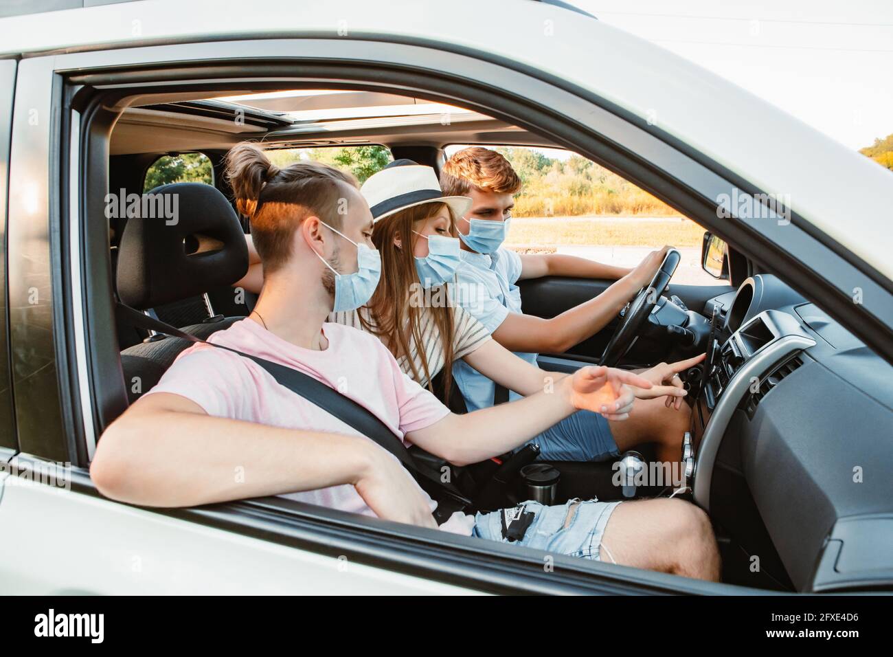 group of people riding in car with medical mask Stock Photo - Alamy