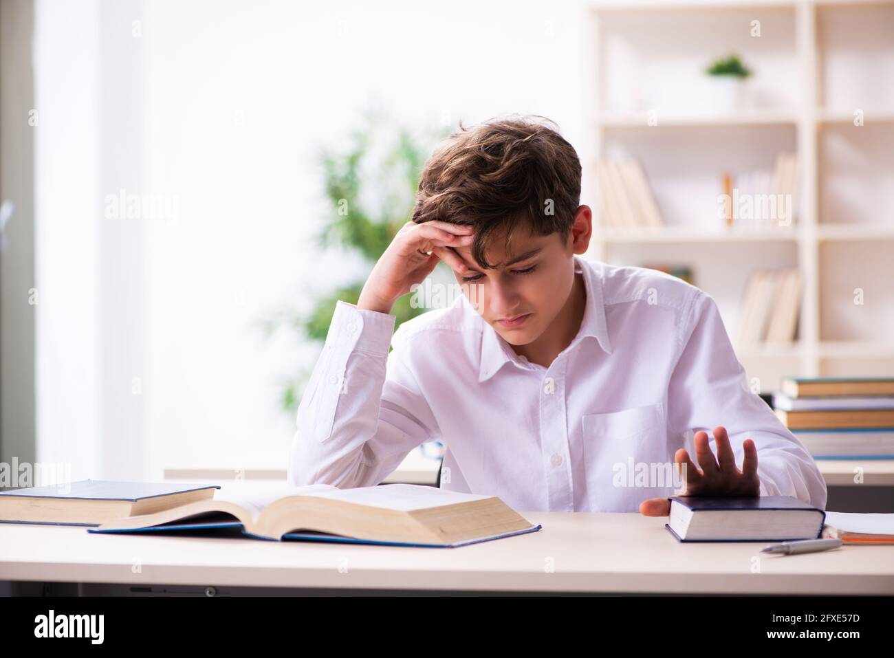 Schoolboy preparing for exam in the classroom Stock Photo - Alamy