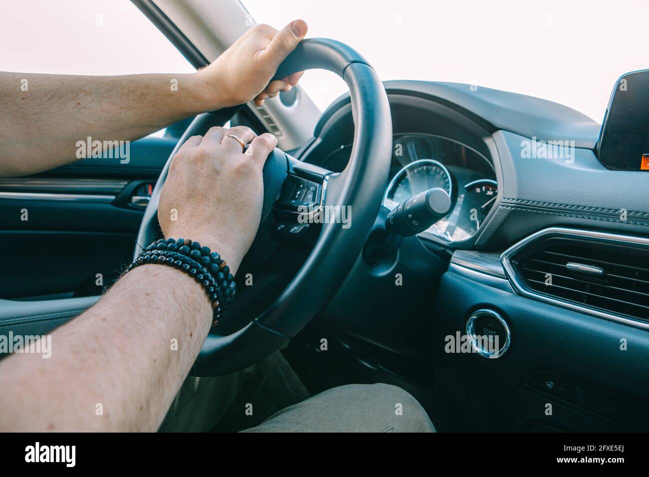 man hands on steering wheel Stock Photo - Alamy