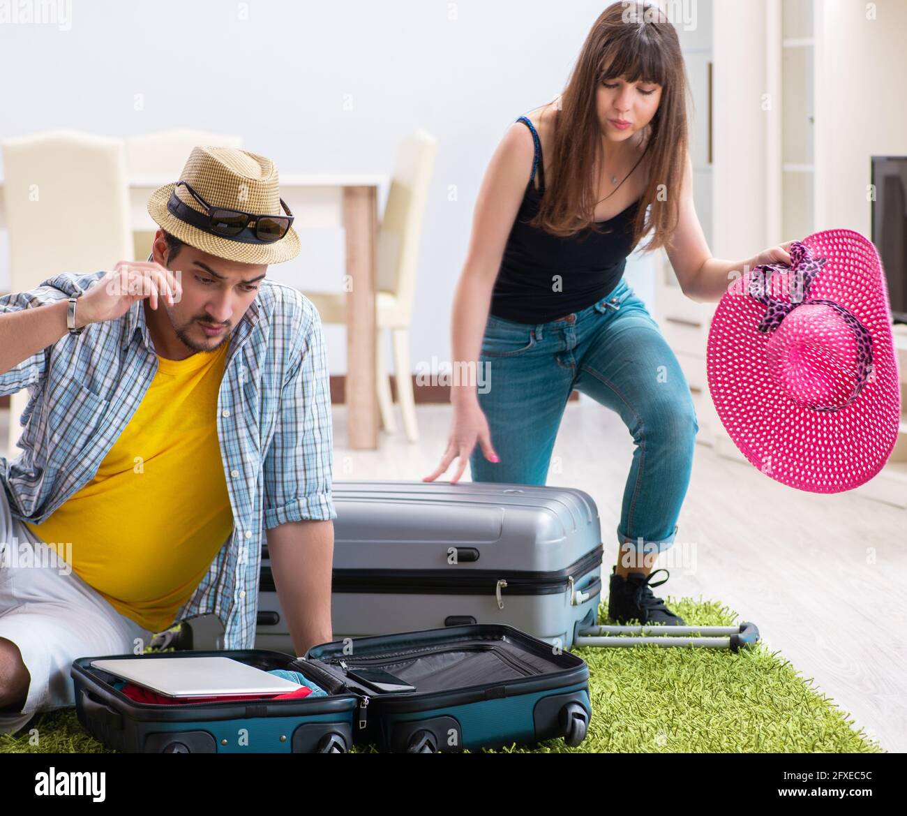The young family packing for vacation travel Stock Photo - Alamy