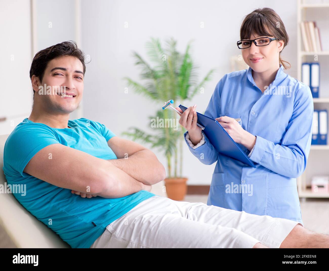 The doctor checking nerve reflexes with hammer Stock Photo - Alamy