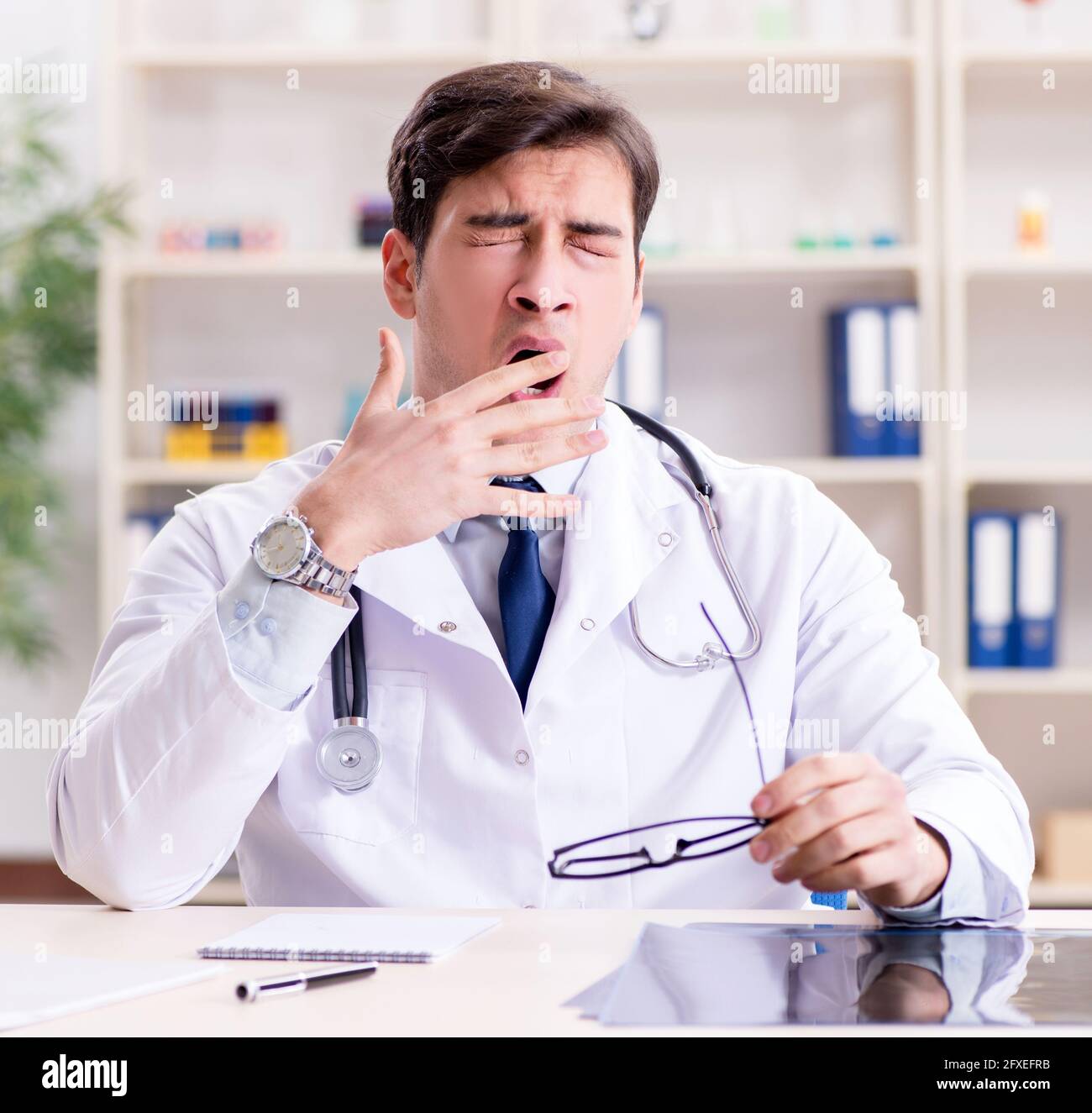 The young doctor sitting in the office Stock Photo - Alamy