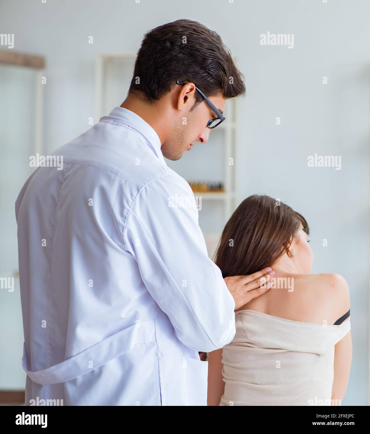 The doctor examining the skin of female patient Stock Photo - Alamy