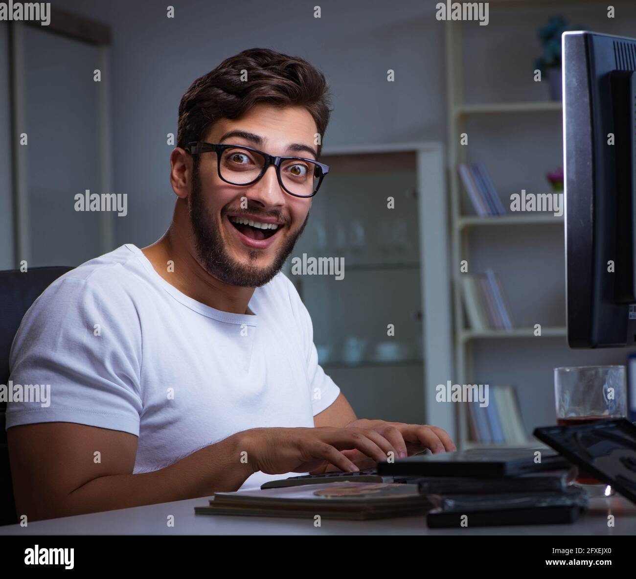 The young man staying late in office to do overtime work Stock Photo ...