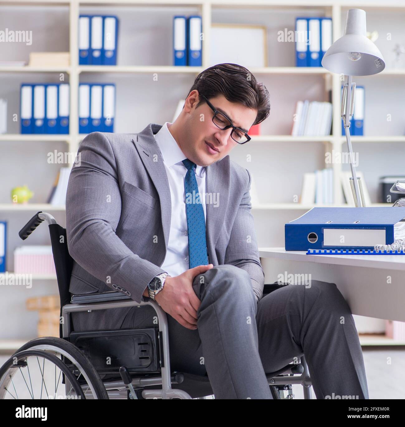 The disabled businessman working in the office Stock Photo - Alamy