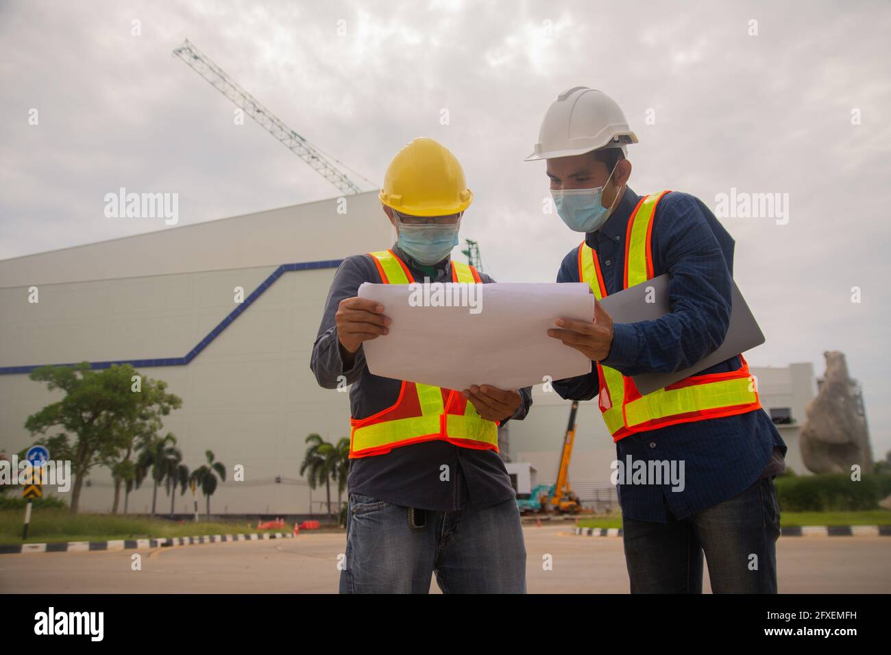 two engineer teamwork working blueprint on site construction,Engineer ...