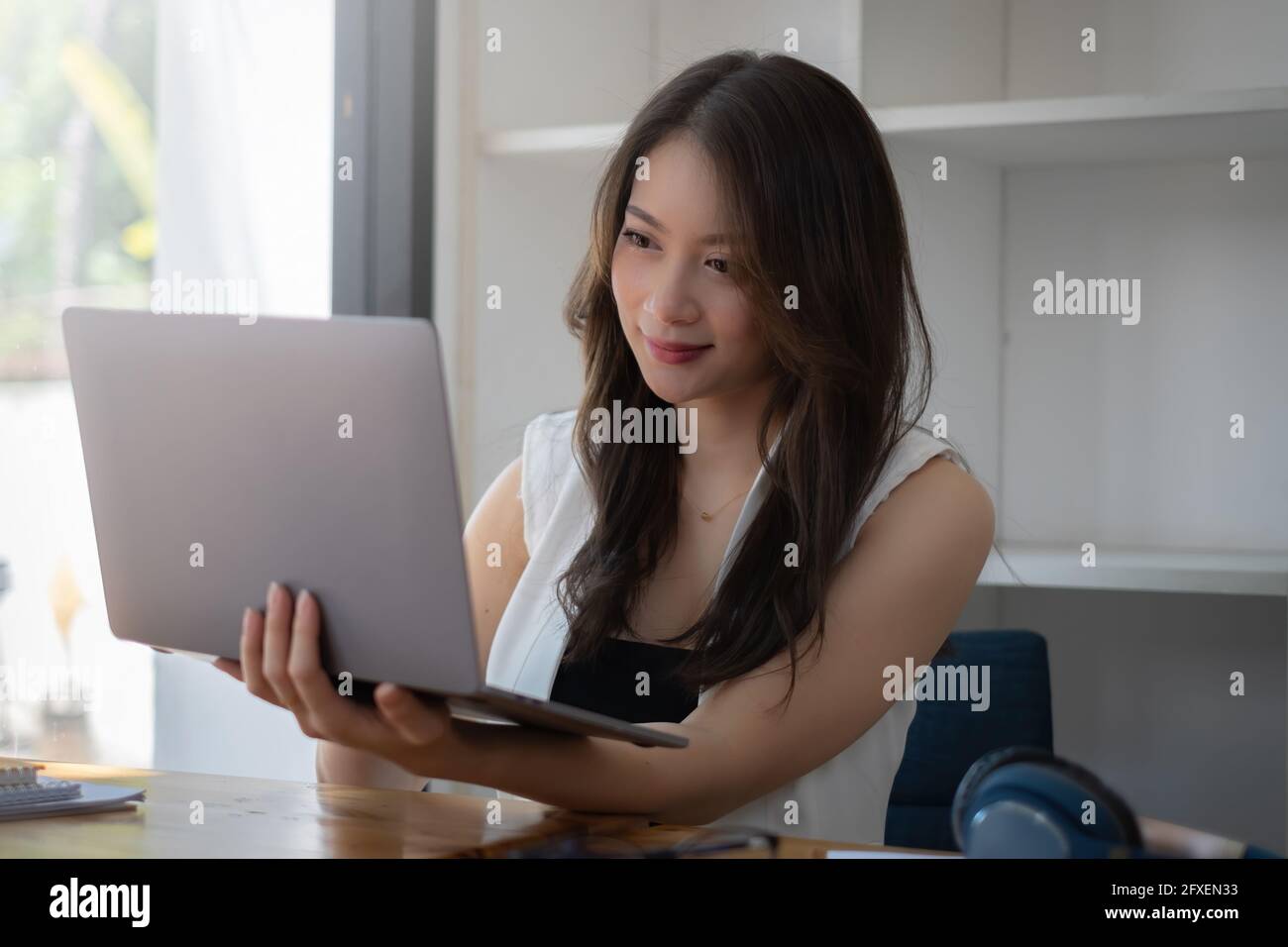 Young woman blogger influencer sit and make video conference call ...