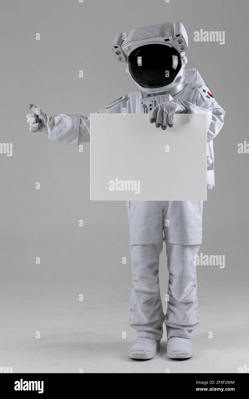 Astronaut holding an event banner, white background Stock Photo - Alamy