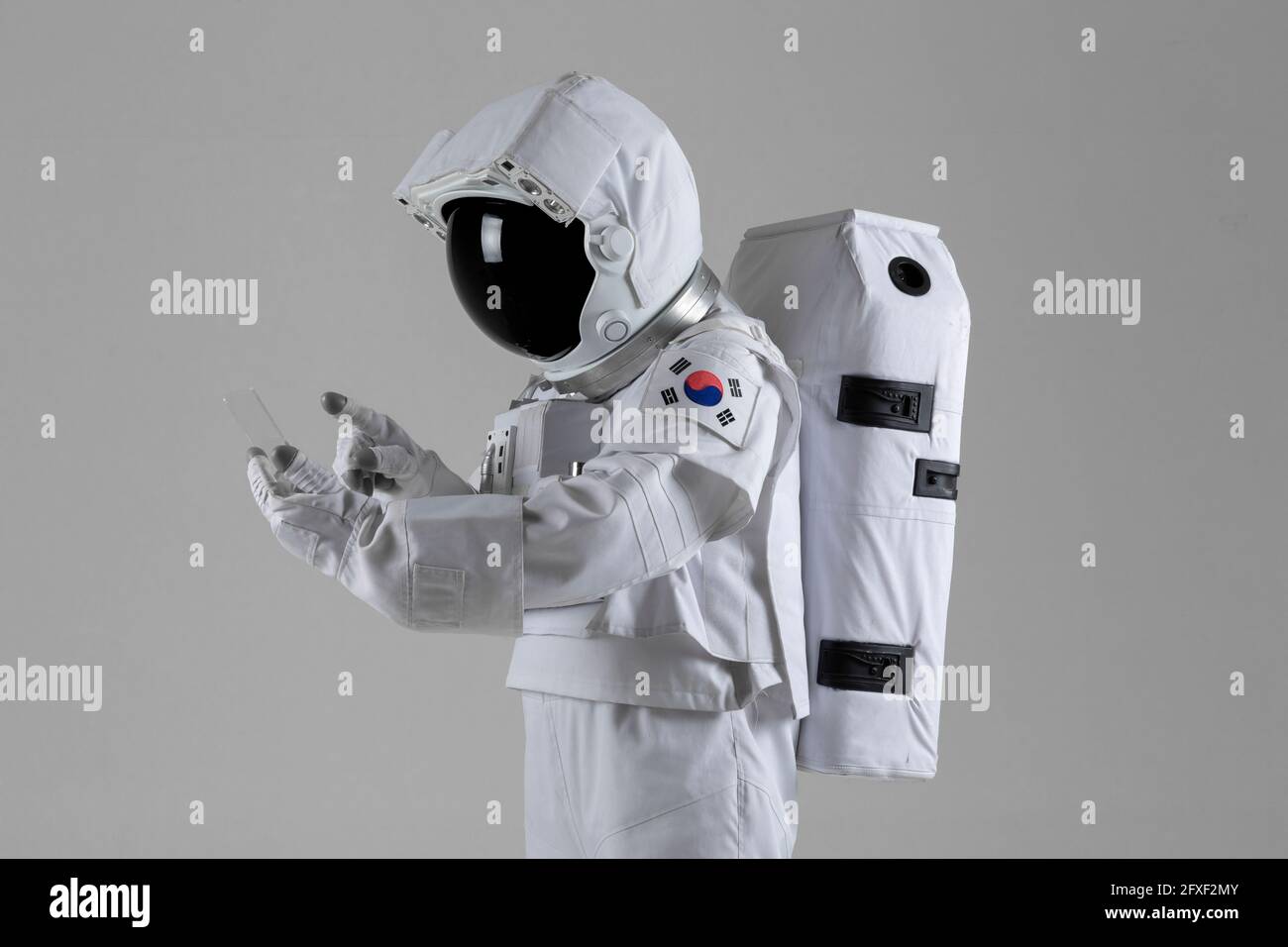 Astronaut using a mobile phone, white background Stock Photo - Alamy