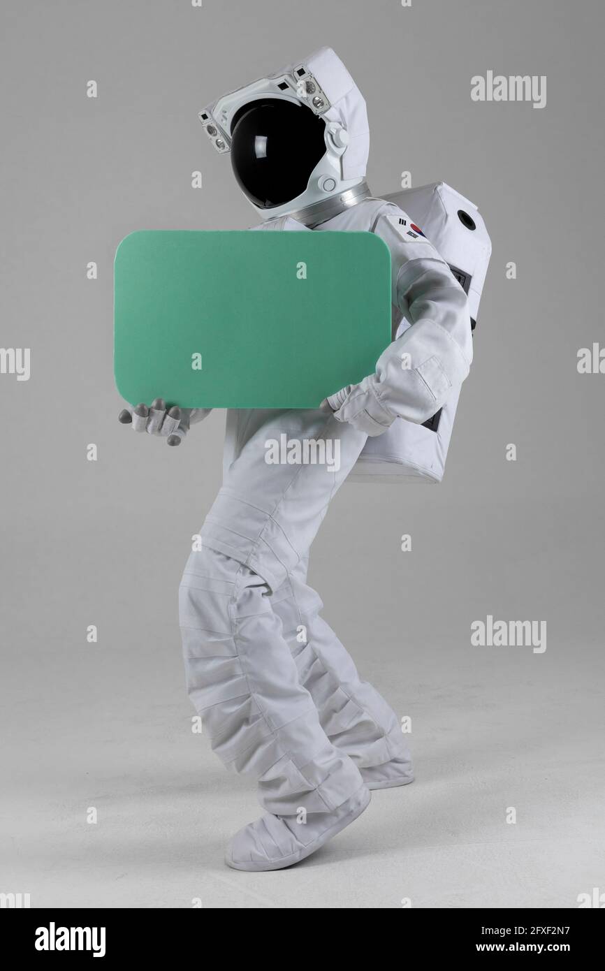 Astronaut holding an event banner, white background Stock Photo - Alamy
