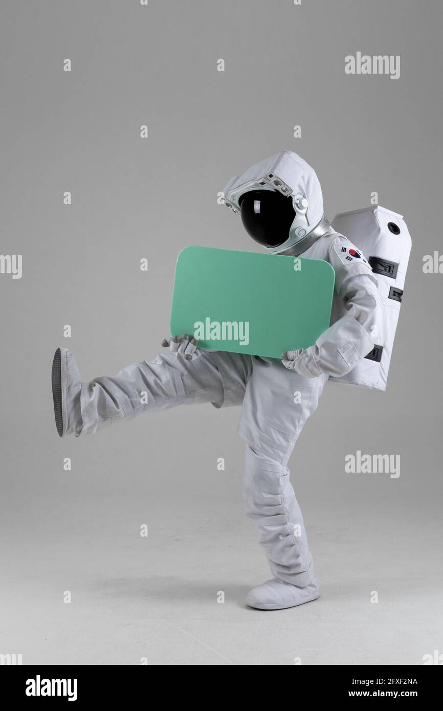 Astronaut holding an event banner, white background Stock Photo - Alamy
