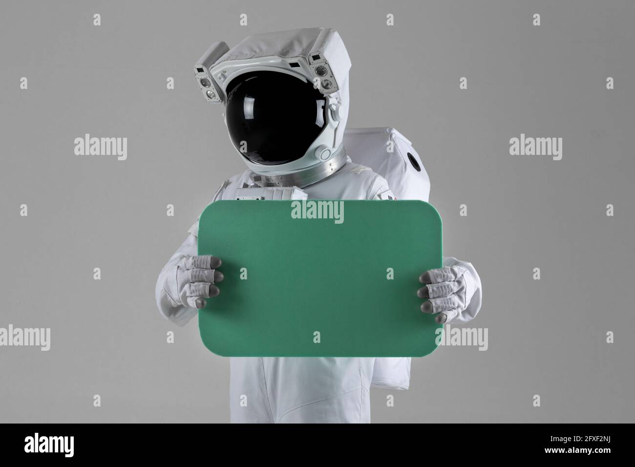 Astronaut holding an event banner, white background Stock Photo - Alamy