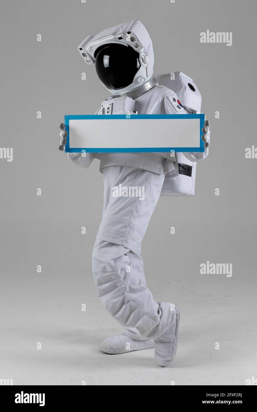Astronaut holding an event banner, white background Stock Photo - Alamy