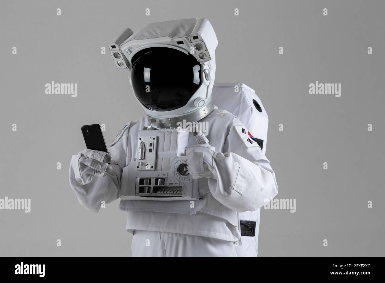 astronaut holding a smart phone with thumbs up, white background Stock ...