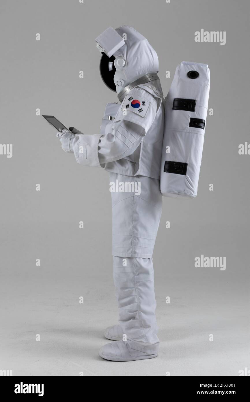 Astronaut watching the Tablet PC, white background Stock Photo - Alamy
