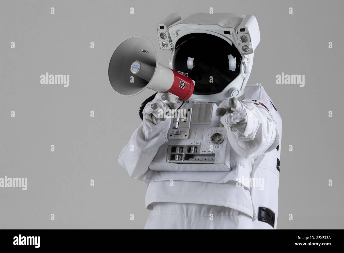 Astronaut shouting with megaphone, white background Stock Photo - Alamy