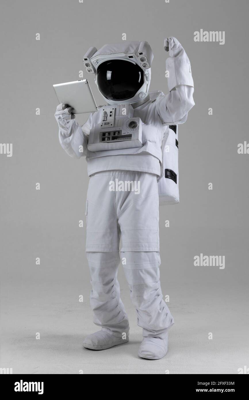 happy astronaut using tablet PC, white background Stock Photo - Alamy