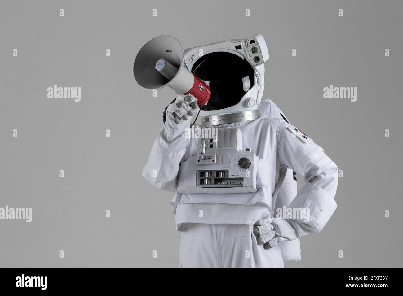 Astronaut shouting with megaphone, white background Stock Photo - Alamy