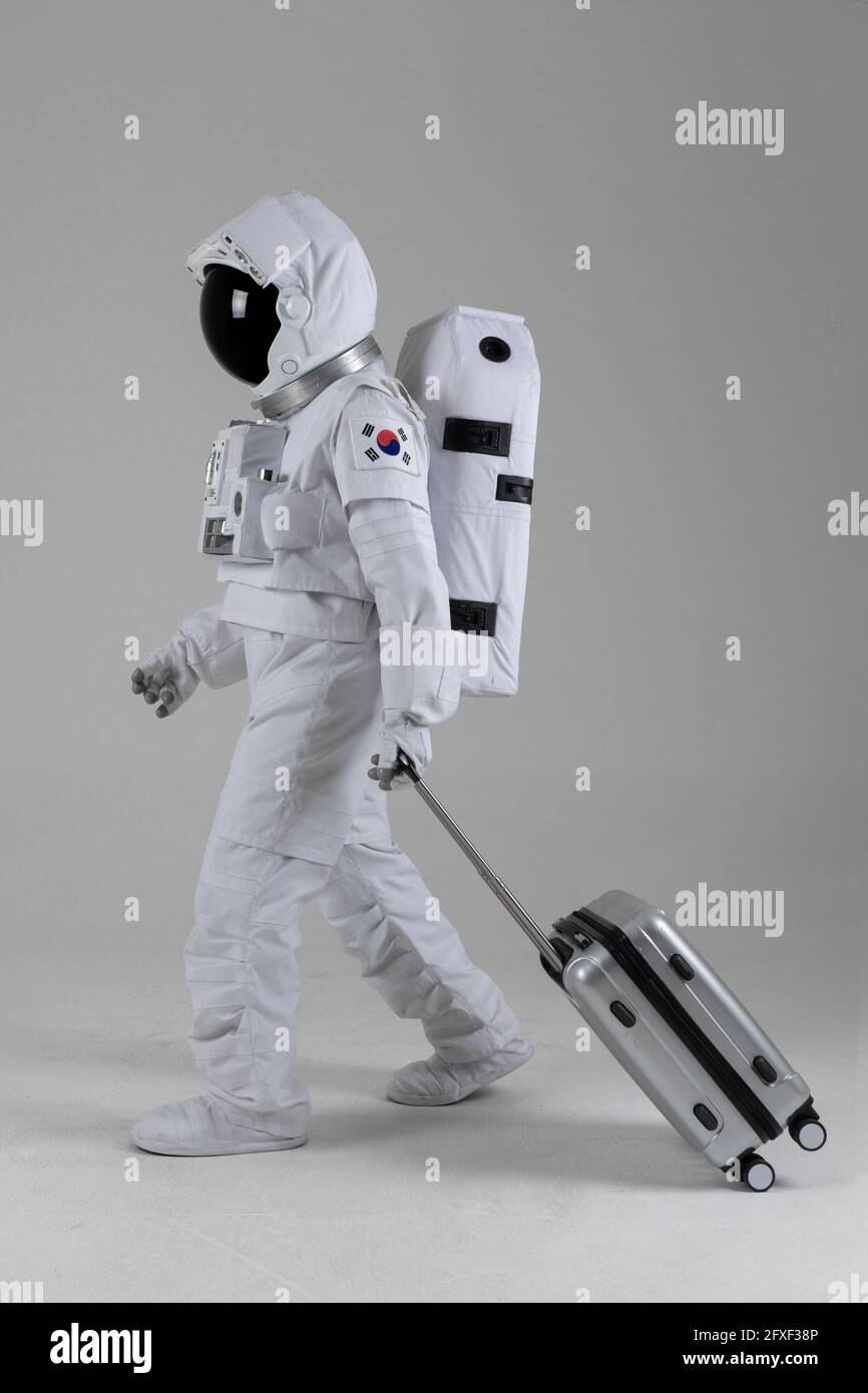astronaut walking with carrier, white background Stock Photo - Alamy