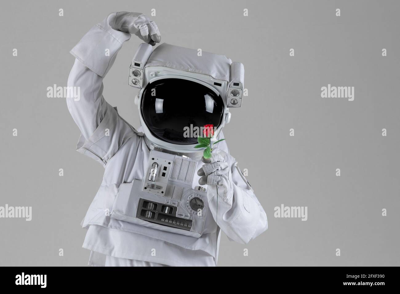 astronaut holding rose, making hand heart signal, white background ...