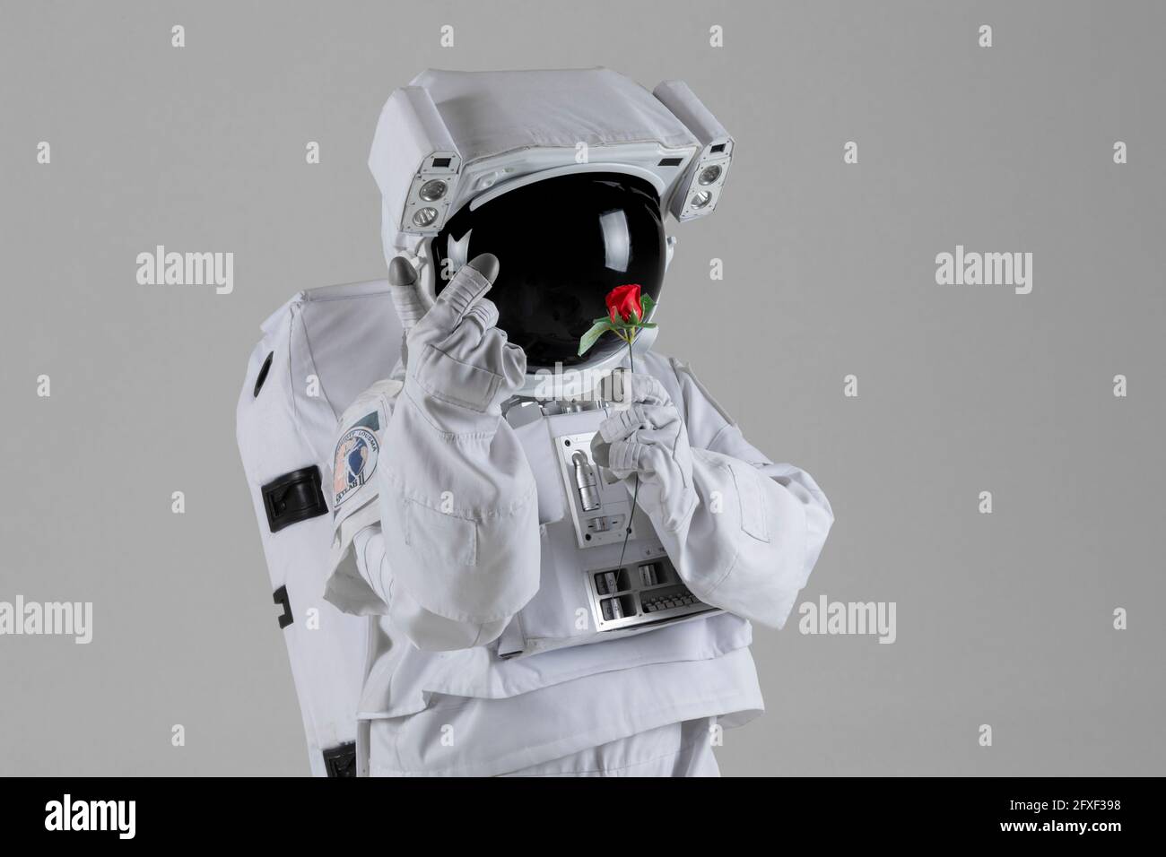 astronaut holding rose, making hand heart signal, white background ...