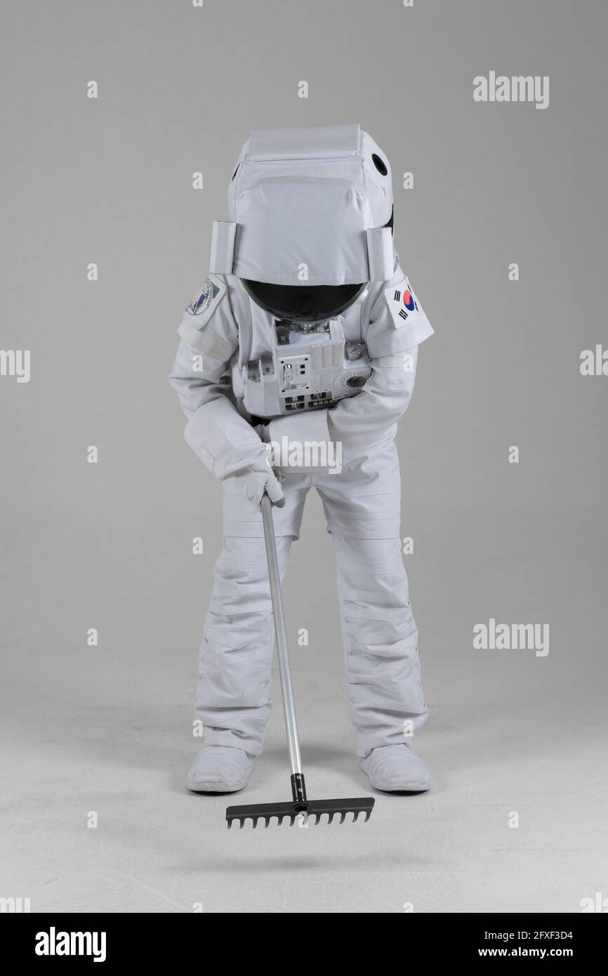 Astronaut used farm equipment, white background Stock Photo - Alamy