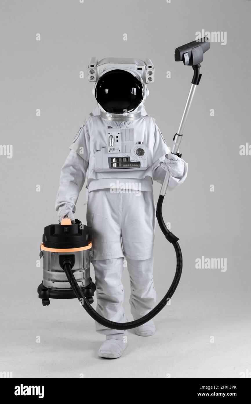 astronaut holding vacuum cleaner, white background Stock Photo - Alamy