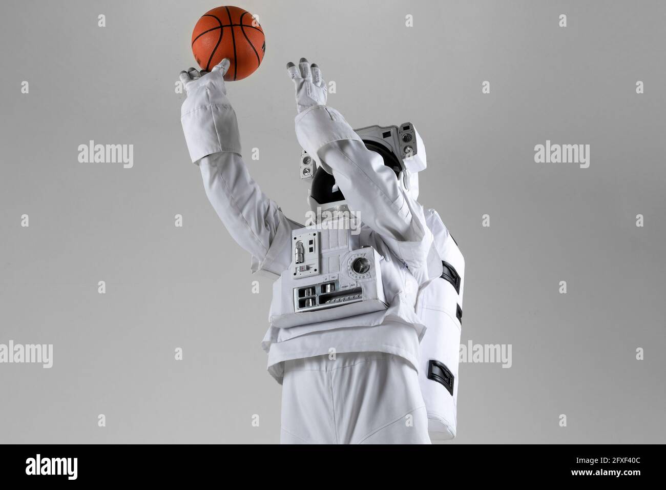 astronaut playing basketball, white background Stock Photo - Alamy